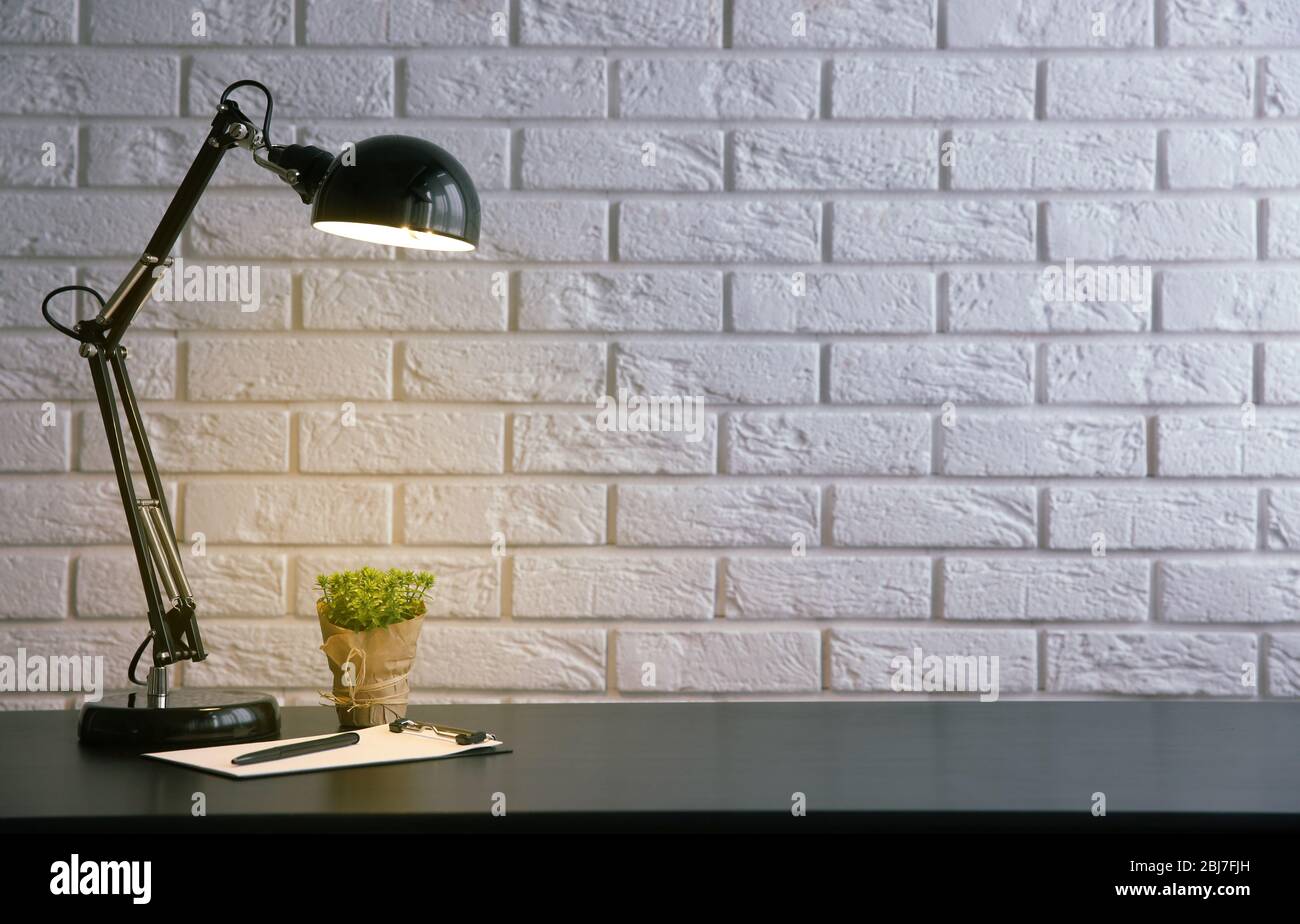 Lamp and plants on the desk on wall background Stock Photo - Alamy