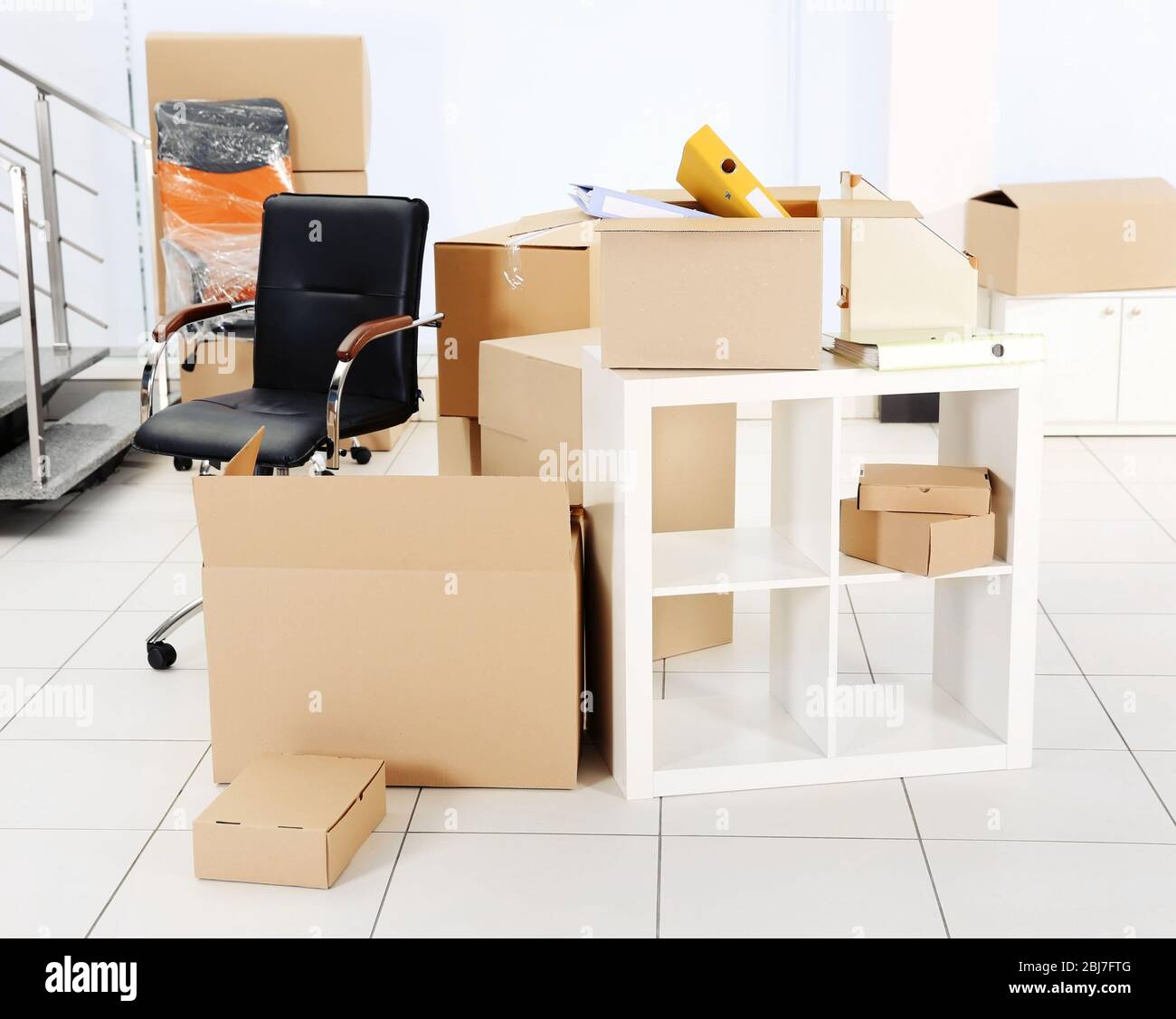 Move concept. Unpacking cardboard boxes in a new office Stock Photo - Alamy
