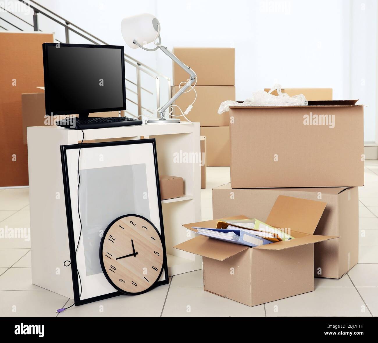 Move concept. Unpacking cardboard boxes in a new office Stock Photo - Alamy