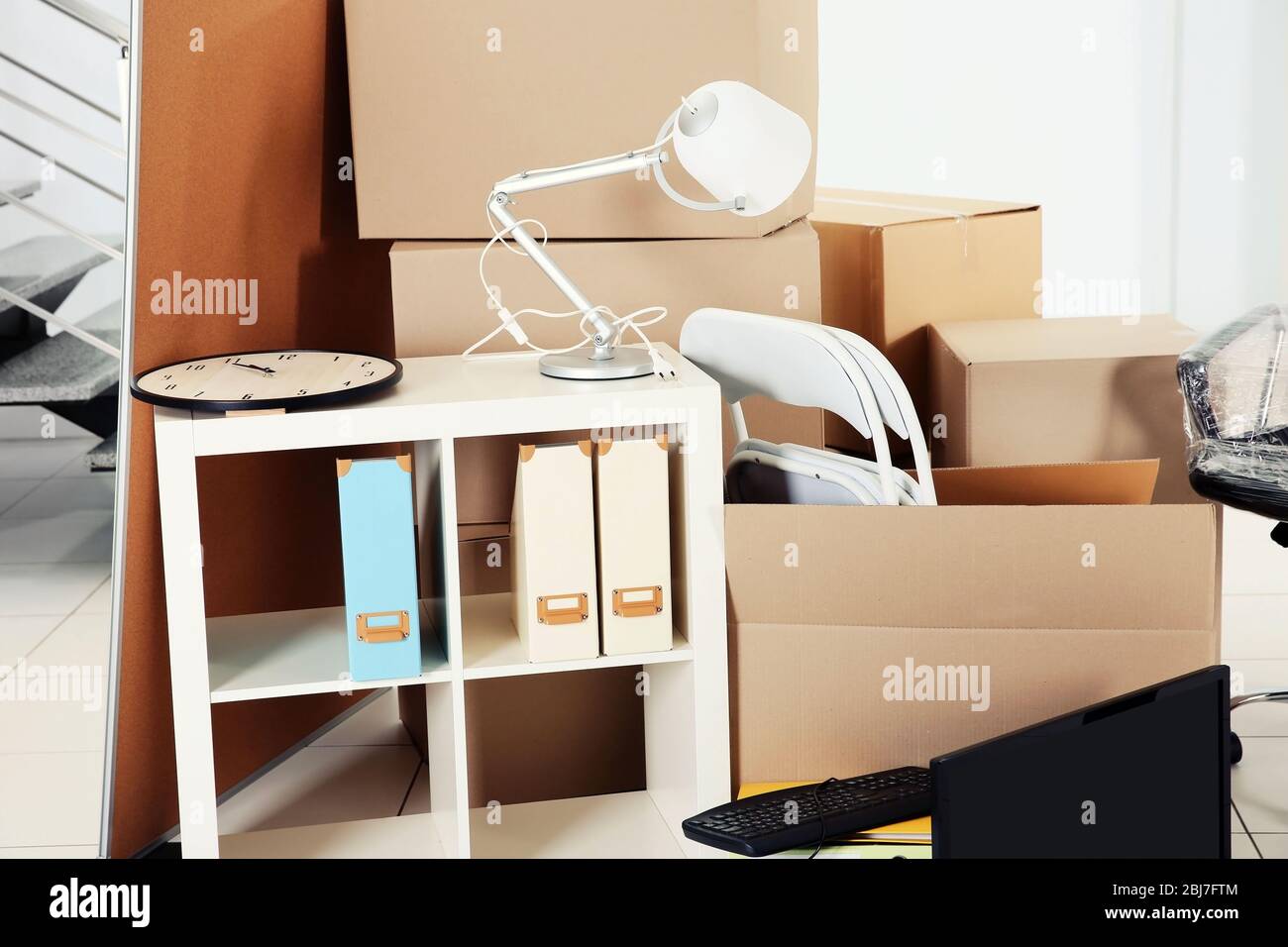 Move concept. Unpacking cardboard boxes in a new office Stock Photo - Alamy