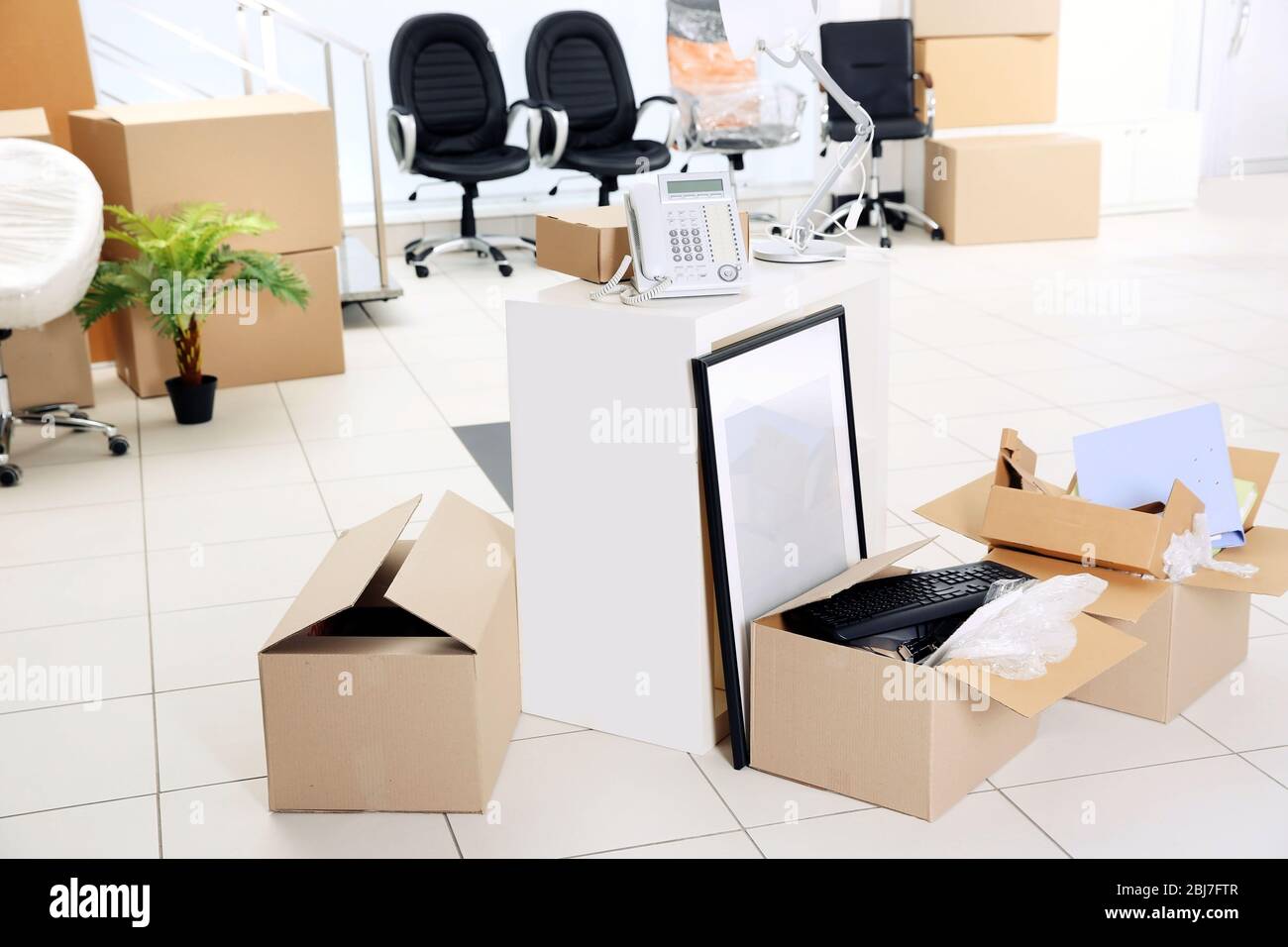 Move concept. Unpacking cardboard boxes in a new office Stock Photo - Alamy