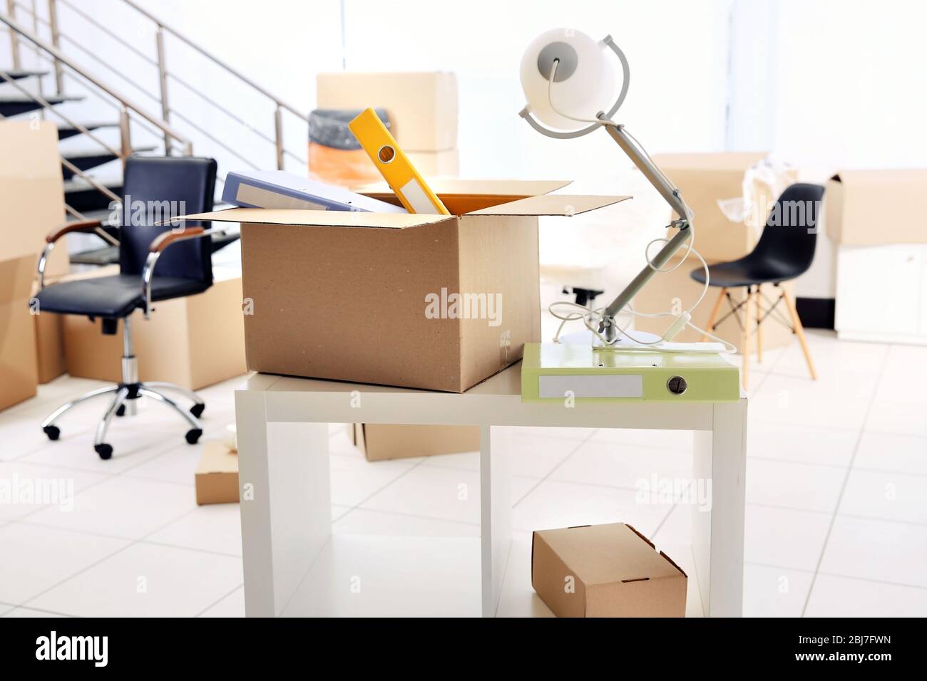 Move concept. Unpacking cardboard boxes in a new office Stock Photo - Alamy