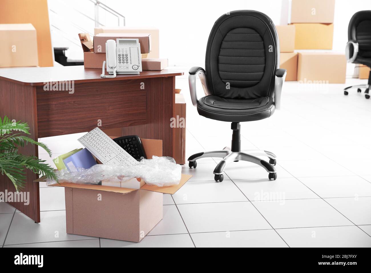 Move concept. Unpacking cardboard boxes in a new office Stock Photo - Alamy