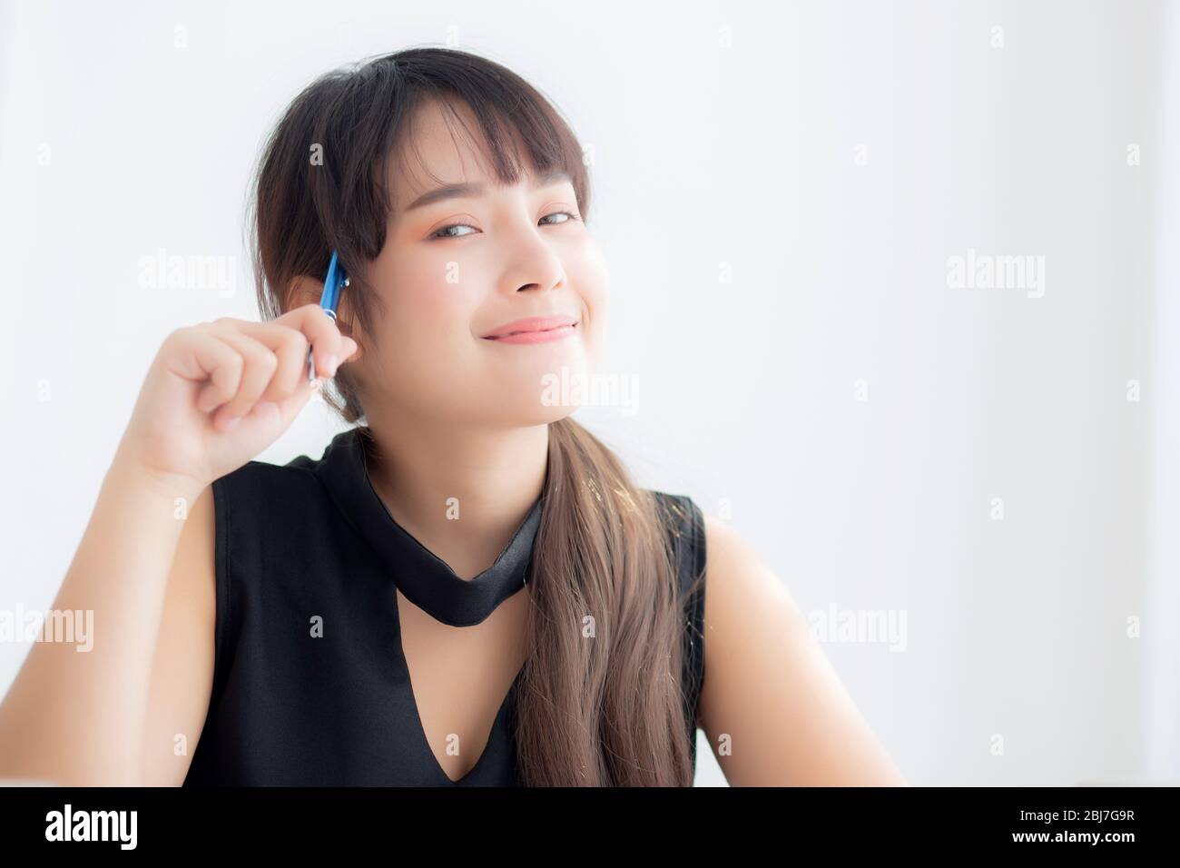 Beautiful asian woman writer smiling thinking idea and writing on ...