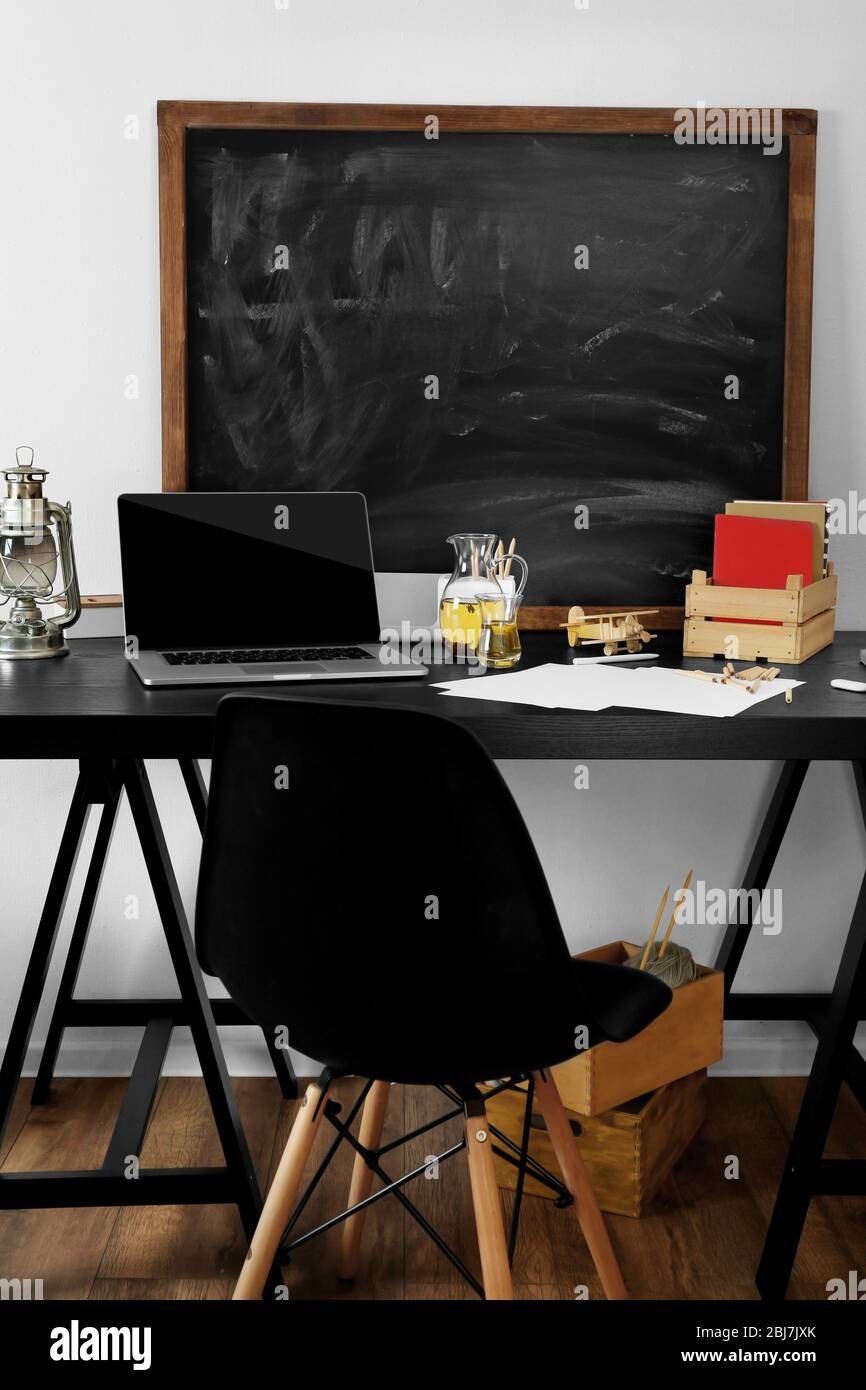 Desktop with notebook and other items on blackboard background Stock ...