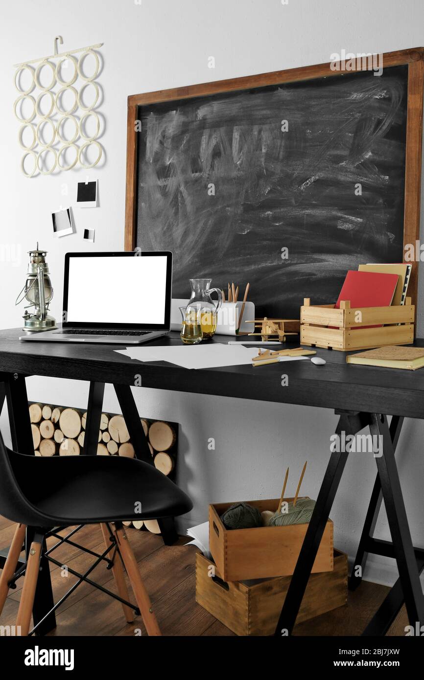 Desktop with notebook and other items on blackboard background Stock ...