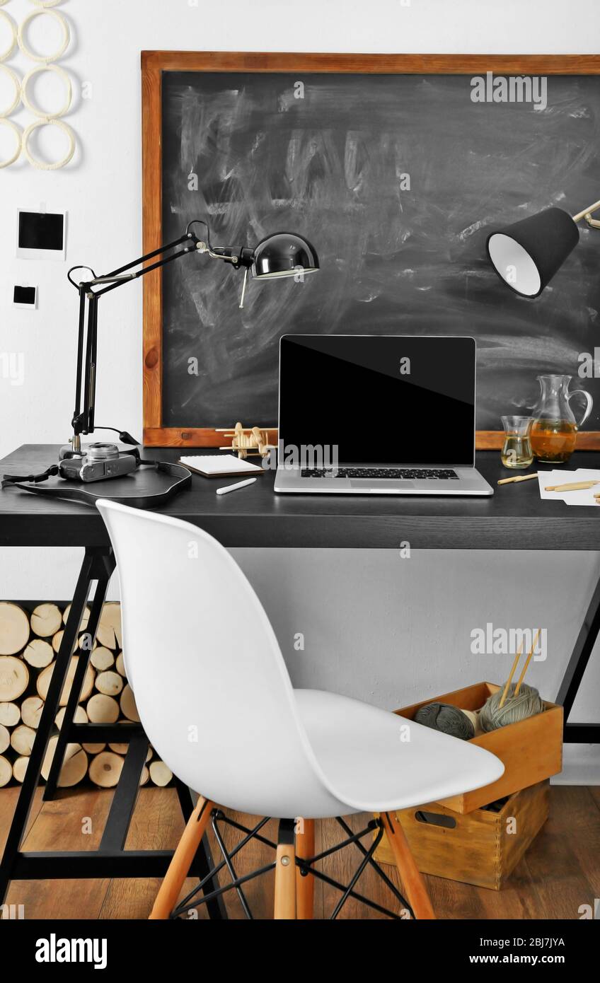Desktop with notebook and other items on blackboard background Stock ...