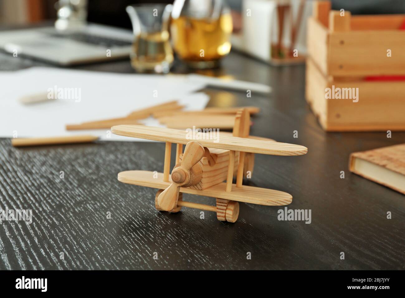 Small wooden model of airplane on desktop closeup Stock Photo - Alamy