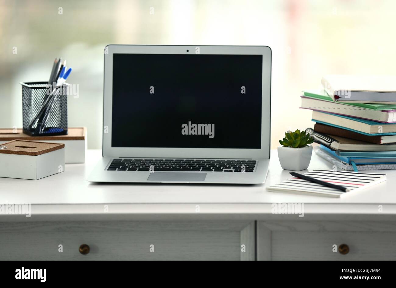 Laptop on the table in the office Stock Photo - Alamy