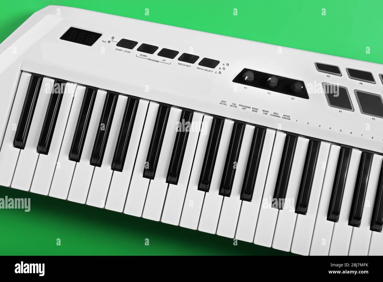 Keyboard of synthesizer on green background Stock Photo - Alamy