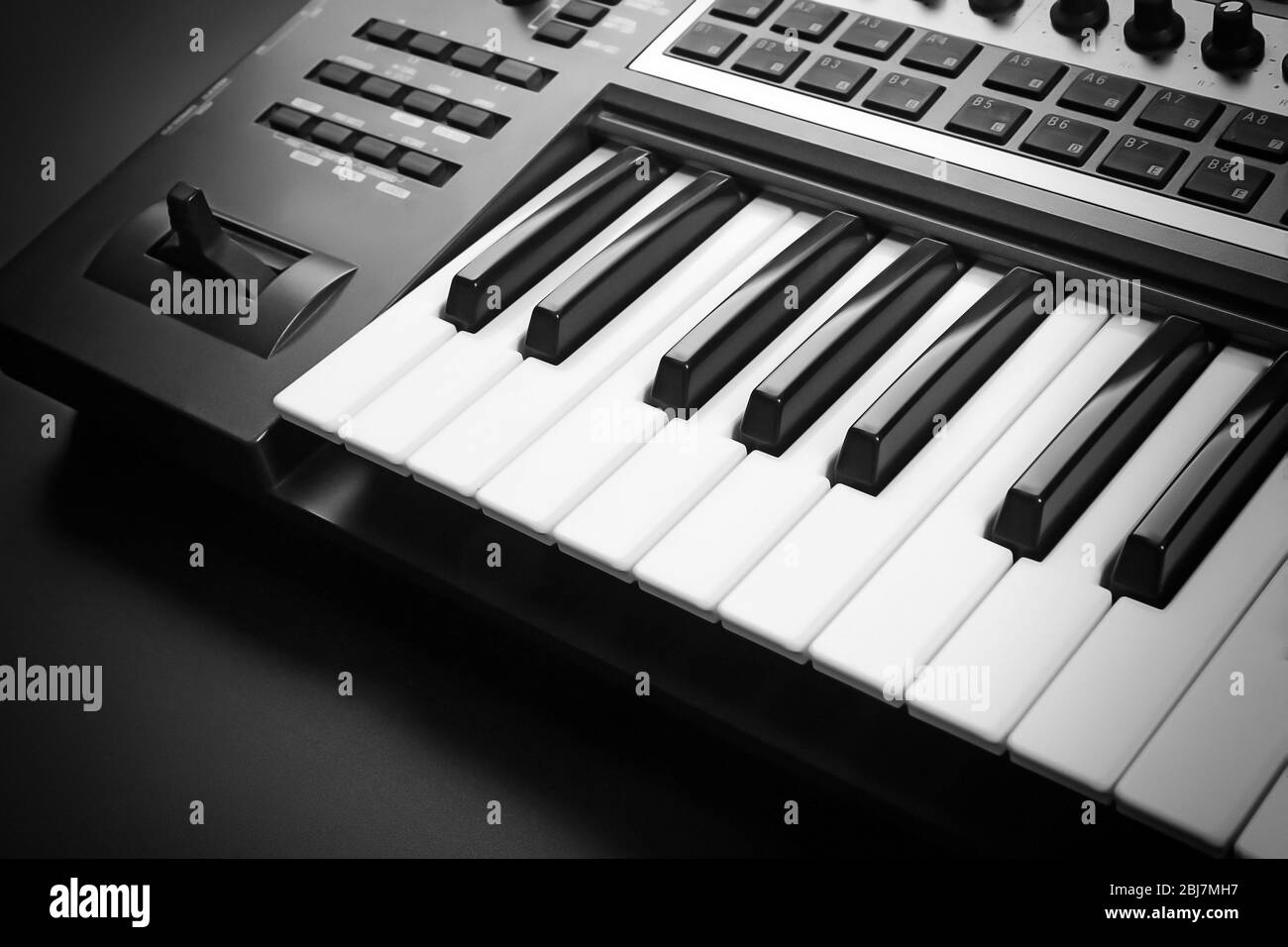 Keyboard of synthesizer on black background Stock Photo - Alamy