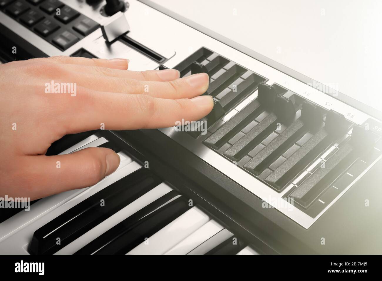 Male hand playing of synthesizer closeup Stock Photo - Alamy