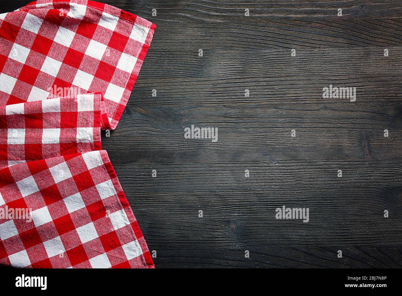 Checkered napkin on wooden background Stock Photo - Alamy