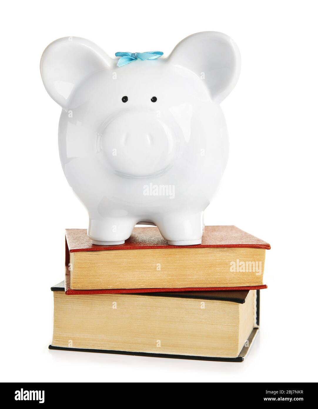 Piggy bank on books, isolated on white Stock Photo - Alamy
