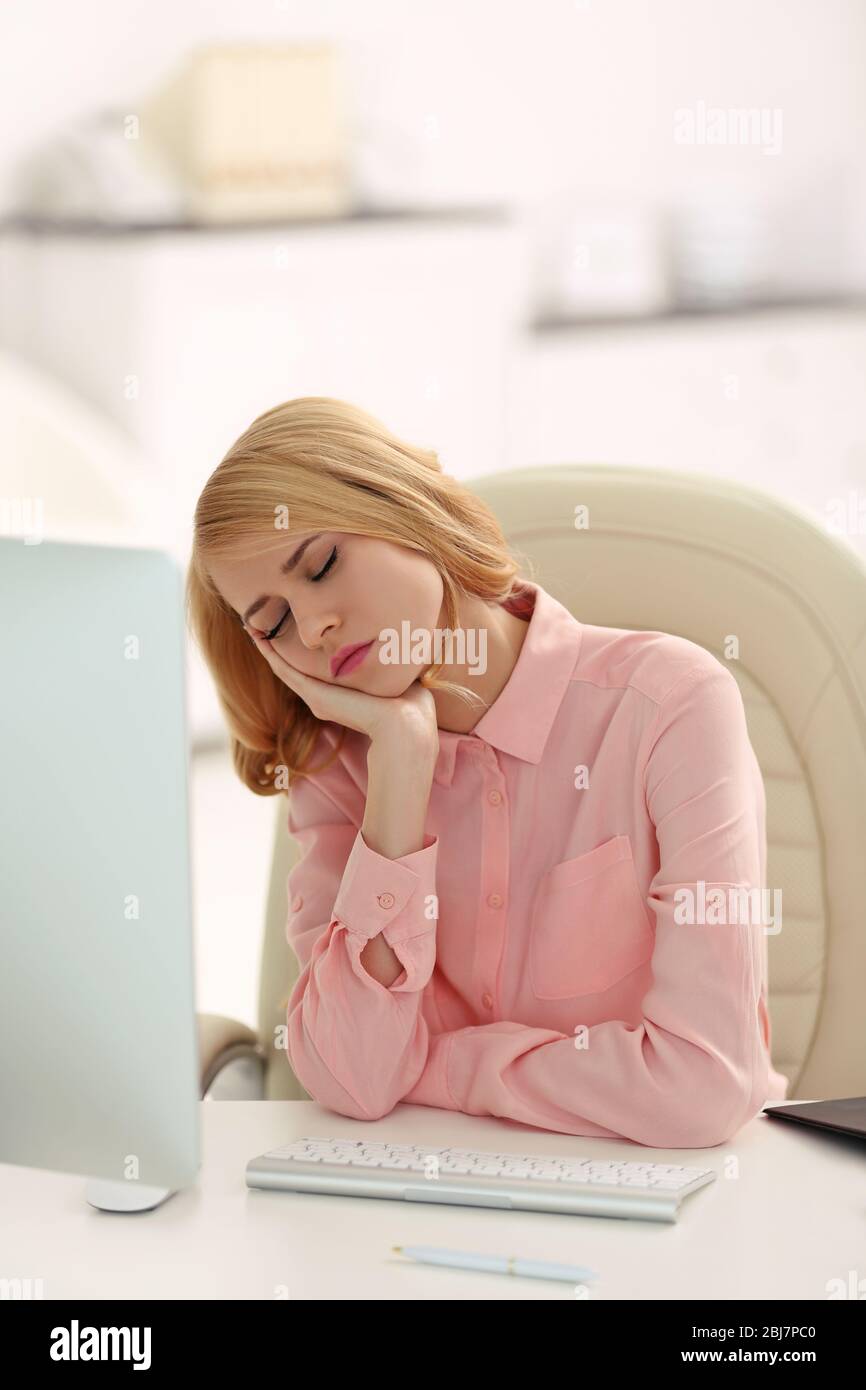 Tired woman at the computer in office Stock Photo - Alamy