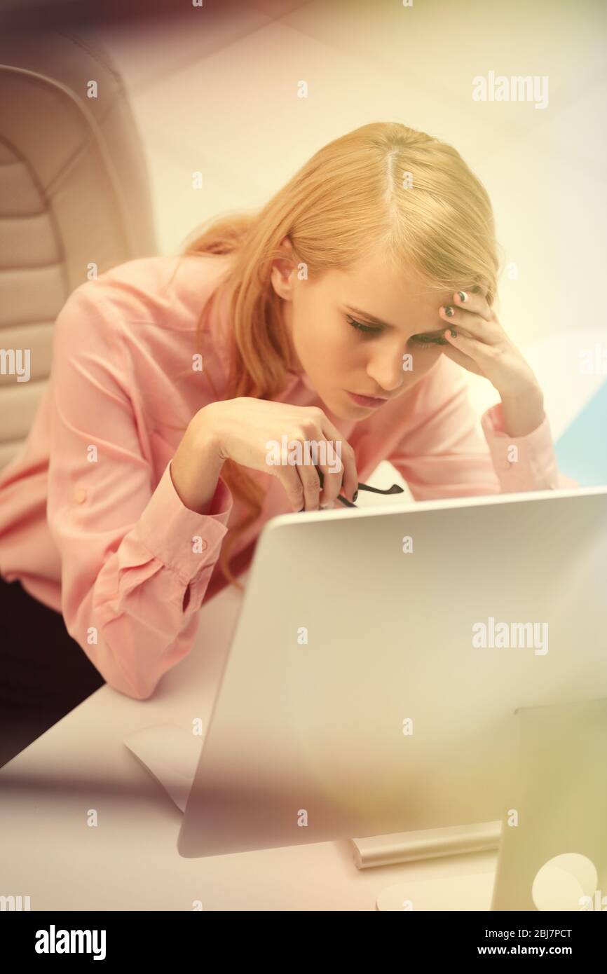 Tired woman at the computer in office Stock Photo - Alamy