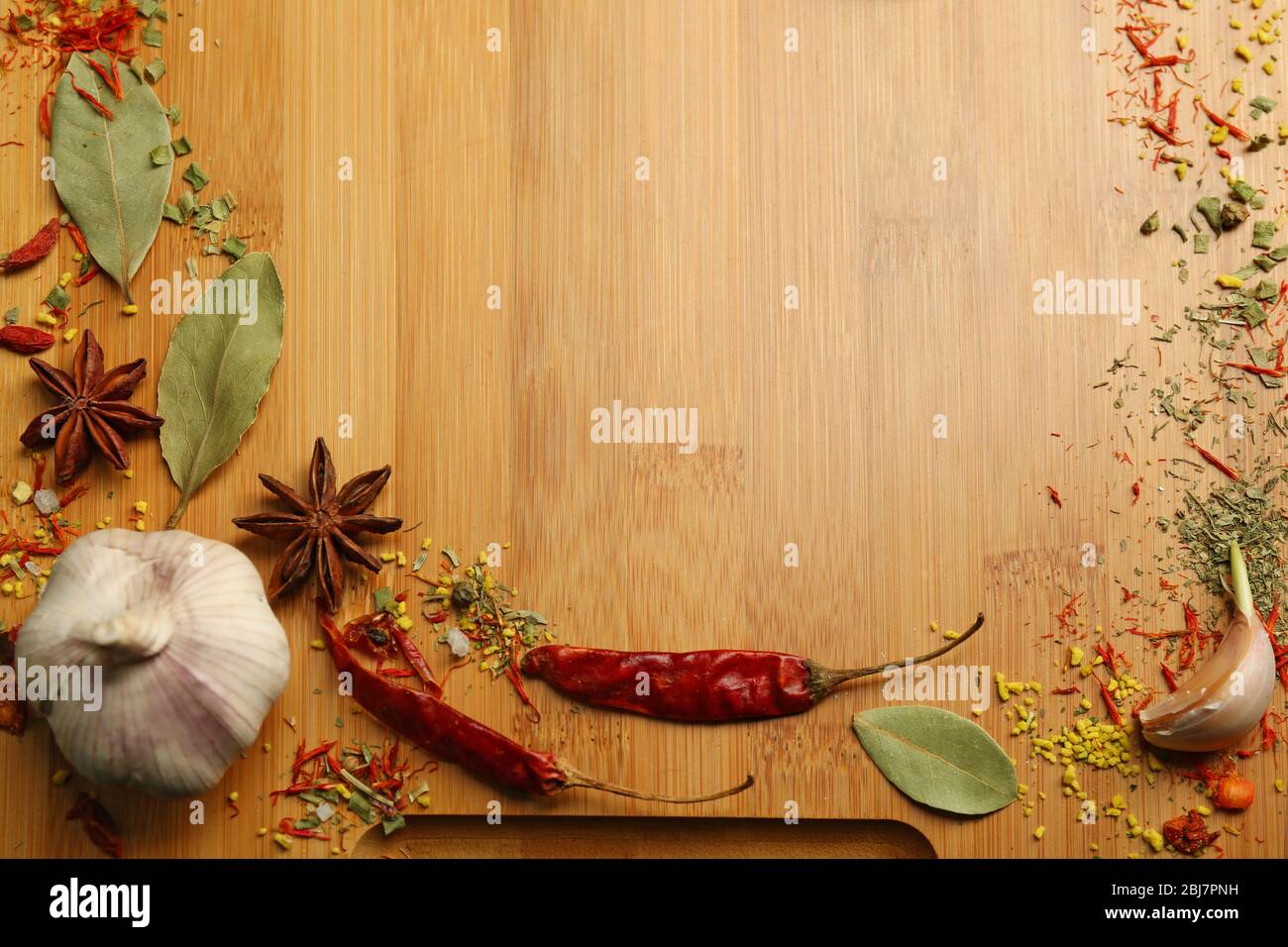 Spices frame on cutting board Stock Photo - Alamy