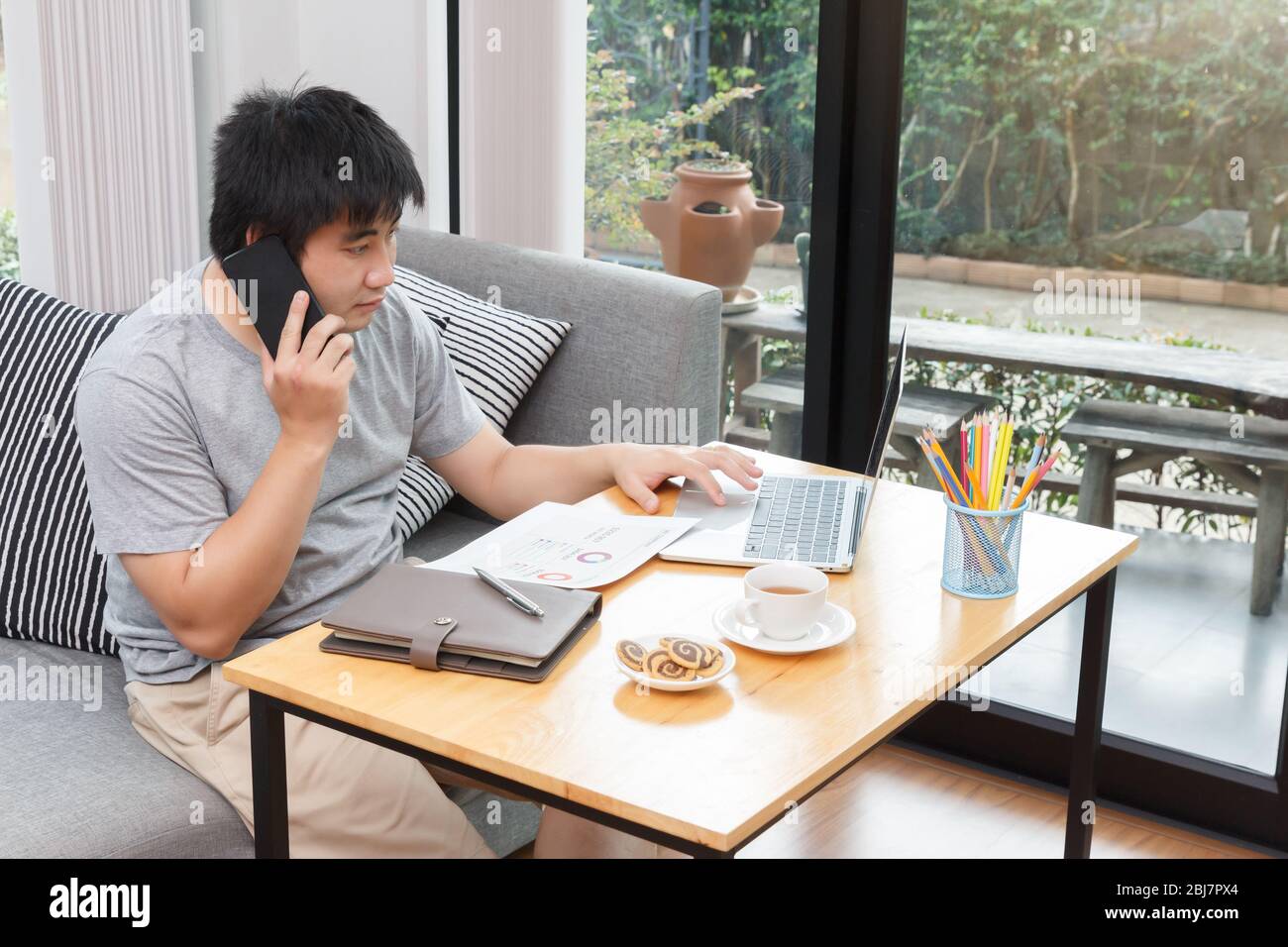 Work from home,Businessman working remotely from home. Using computer ...