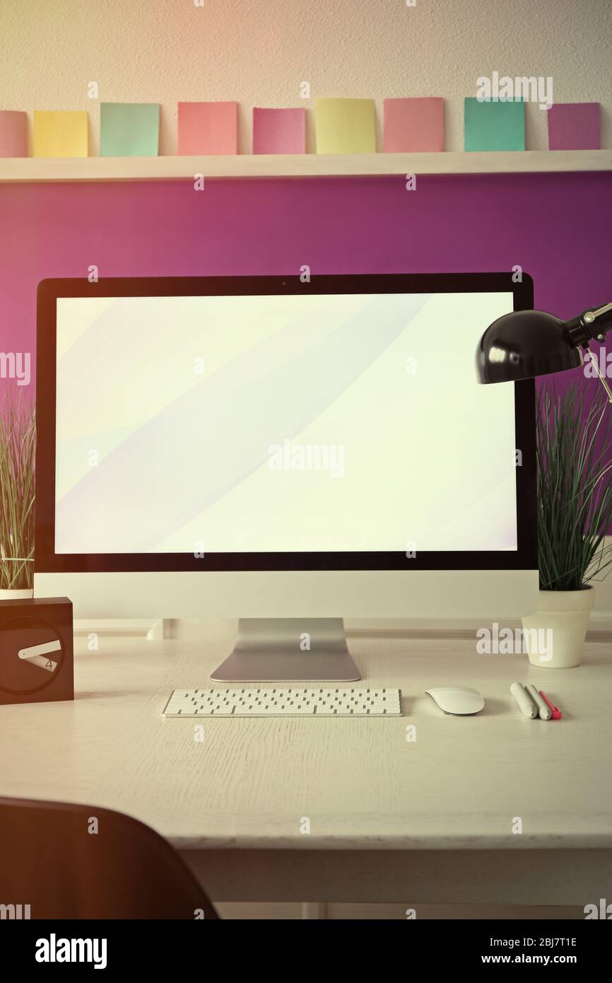 Stylish workplace with computer and interior decorations Stock Photo ...