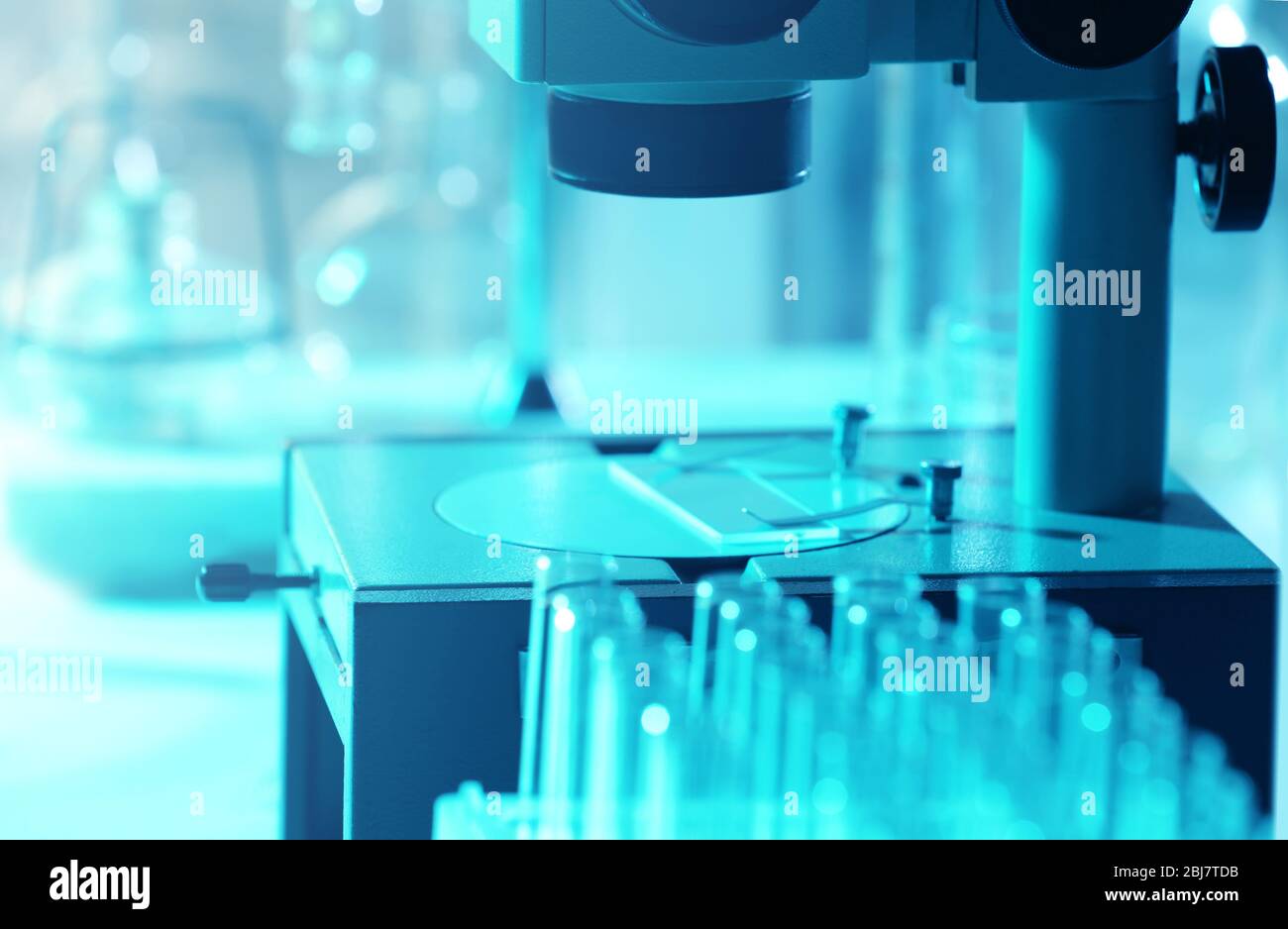 Microscope and different test tubes and flasks in laboratory Stock ...