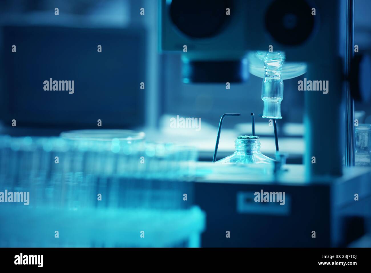 Microscope and glassware in laboratory closeup Stock Photo - Alamy