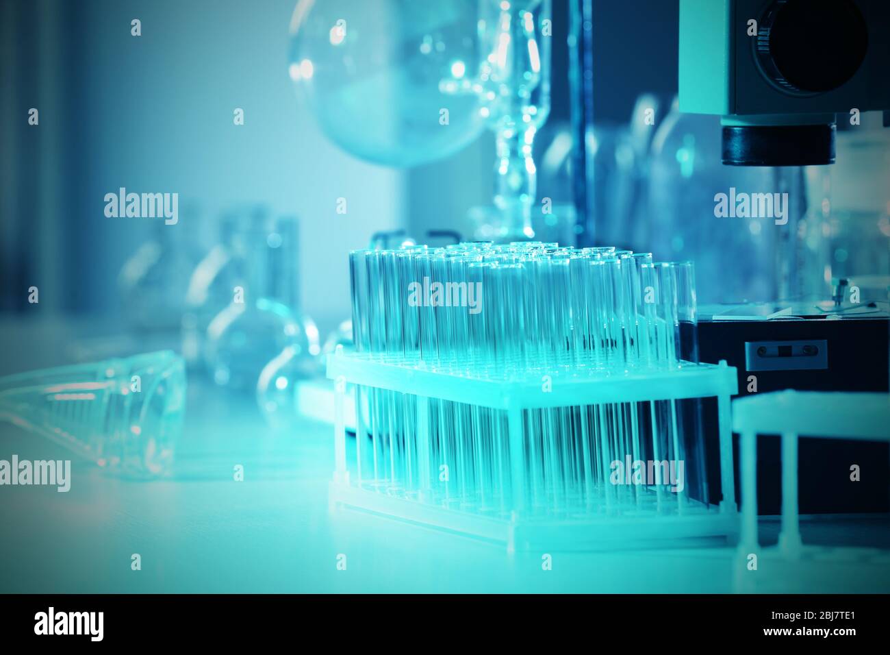 Microscope and glassware in laboratory Stock Photo - Alamy