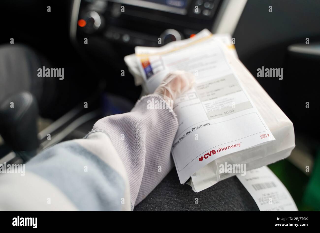 Cromwell, CT / USA - April 20, 2020: Gloved hand holds out a ...