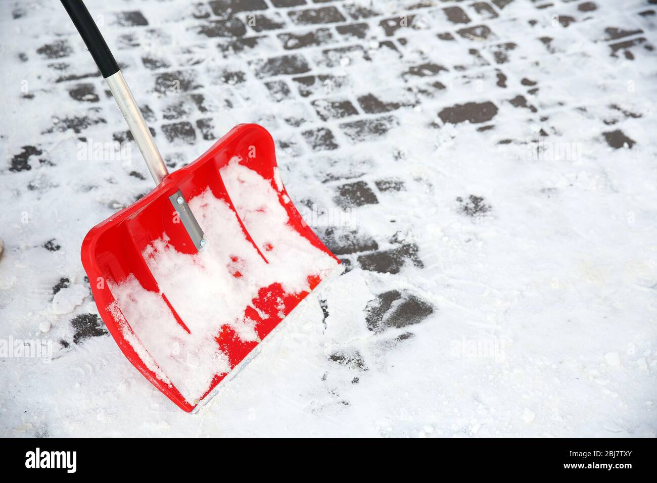 Red plastic shovel for snow Stock Photo - Alamy