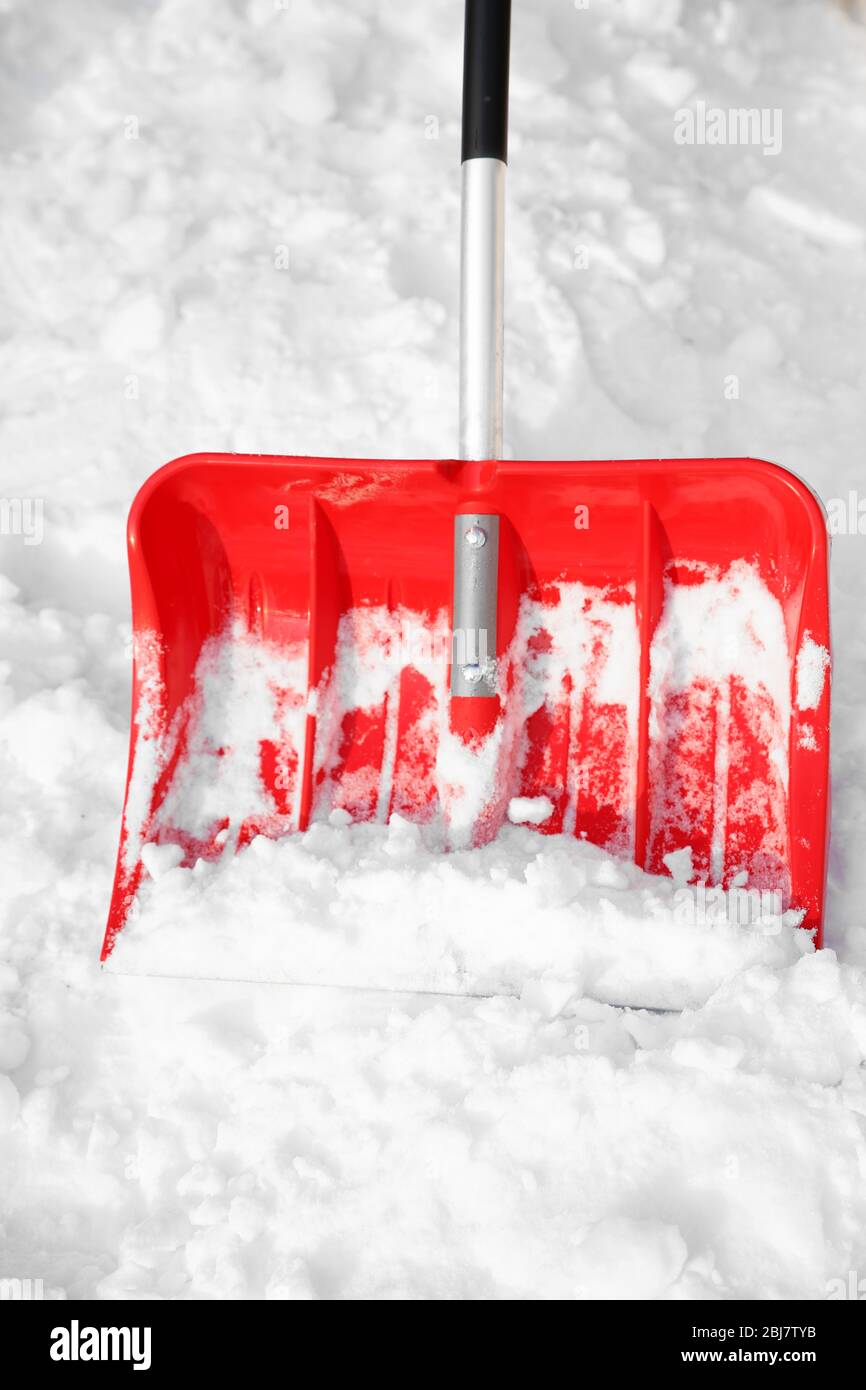 Red plastic shovel for snow Stock Photo - Alamy