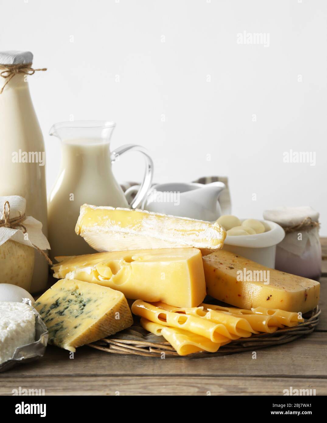 Set of fresh dairy products on wooden table, on white background Stock ...