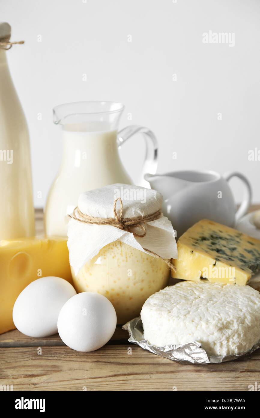Set of fresh dairy products on wooden table, on white background Stock ...