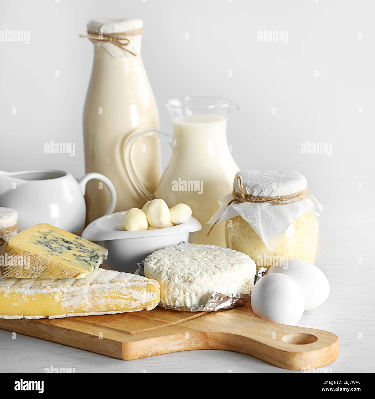 Set of fresh dairy products on wooden table, on white background Stock ...