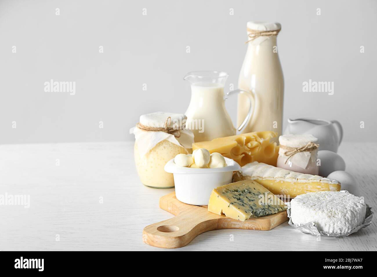 Set of fresh dairy products on wooden table, on white background Stock ...
