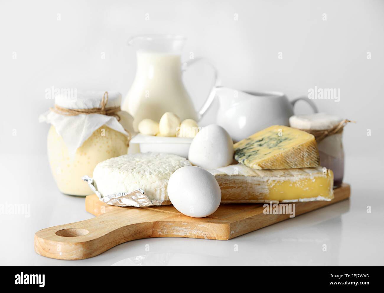 Set of fresh dairy products on wooden table, on white background Stock ...