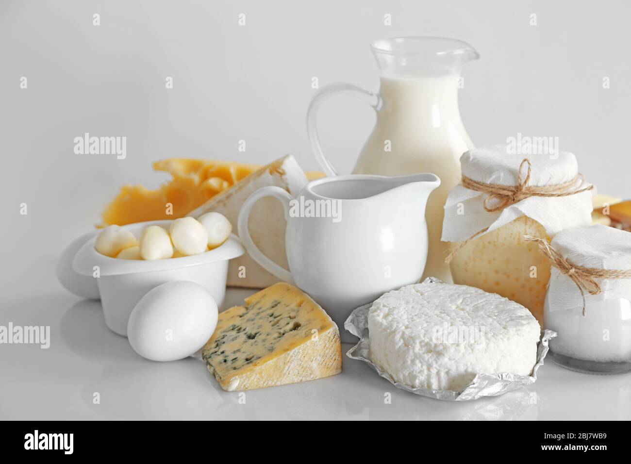 Set of fresh dairy products on wooden table, on white background Stock ...