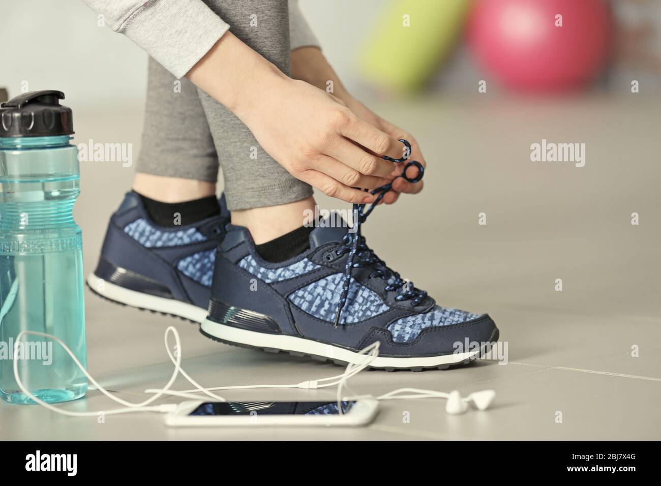 Woman tying up running shoe Stock Photo - Alamy