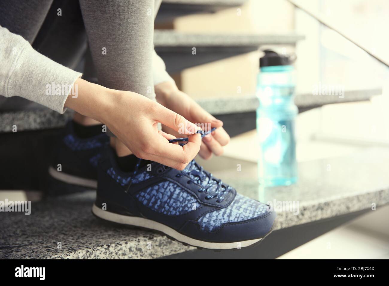 Woman tying up running shoe Stock Photo - Alamy