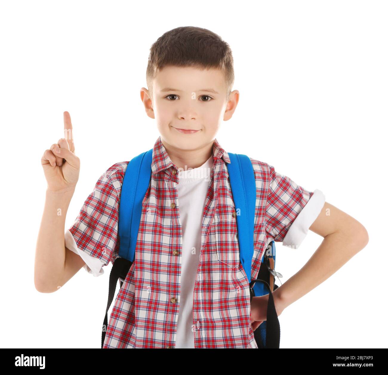 Portrait of little boy with back pack pointing finger upwards, isolated ...