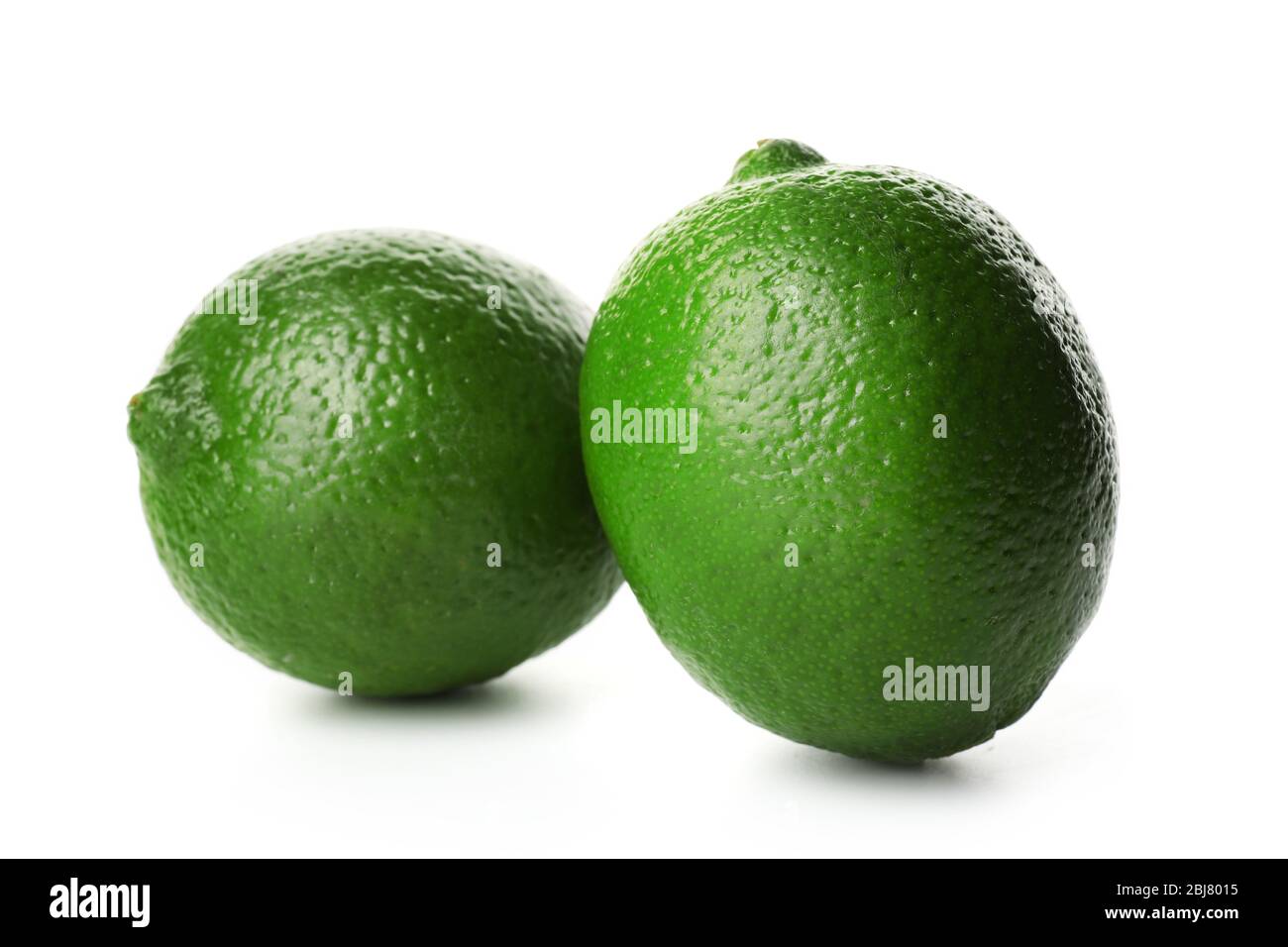 Two limes, isolated on white Stock Photo - Alamy