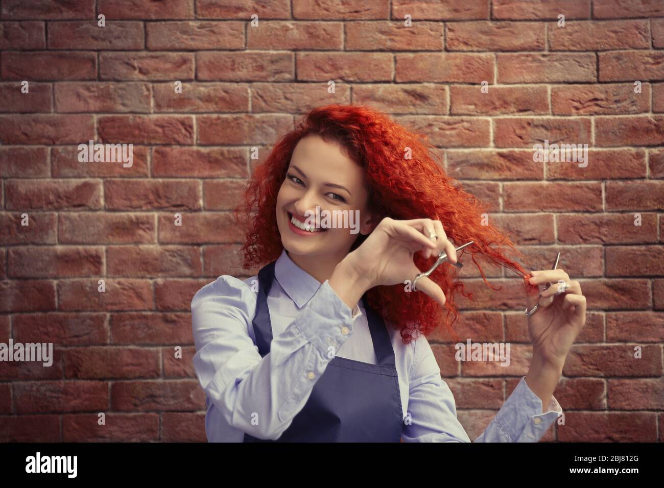 Red haired beautiful girl with scissors Stock Photo - Alamy