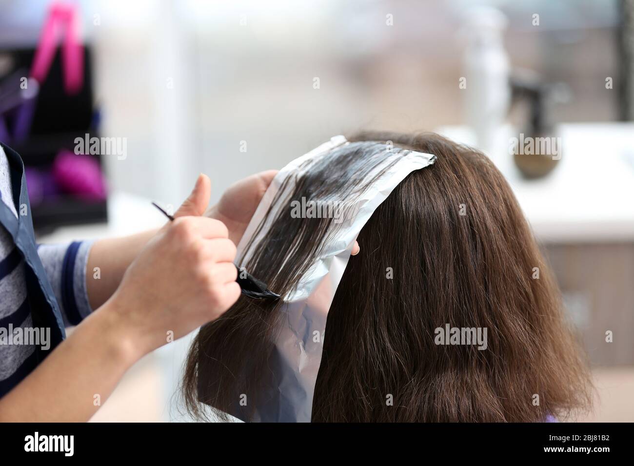 Professional hairdresser coloring hair Stock Photo - Alamy
