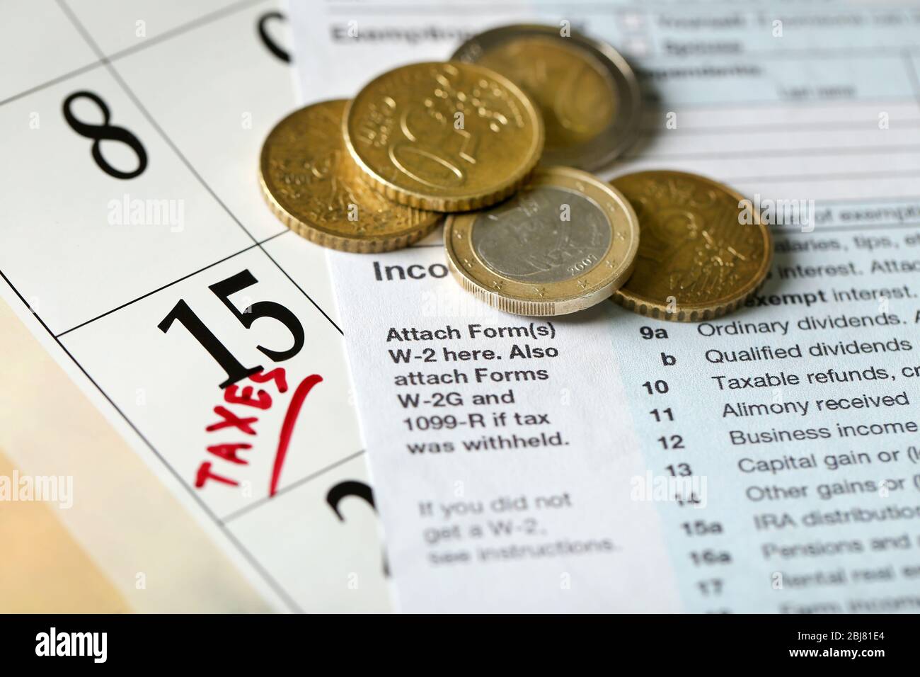 A red tax mark in the calendar, euro coins and tax form, close up Stock ...