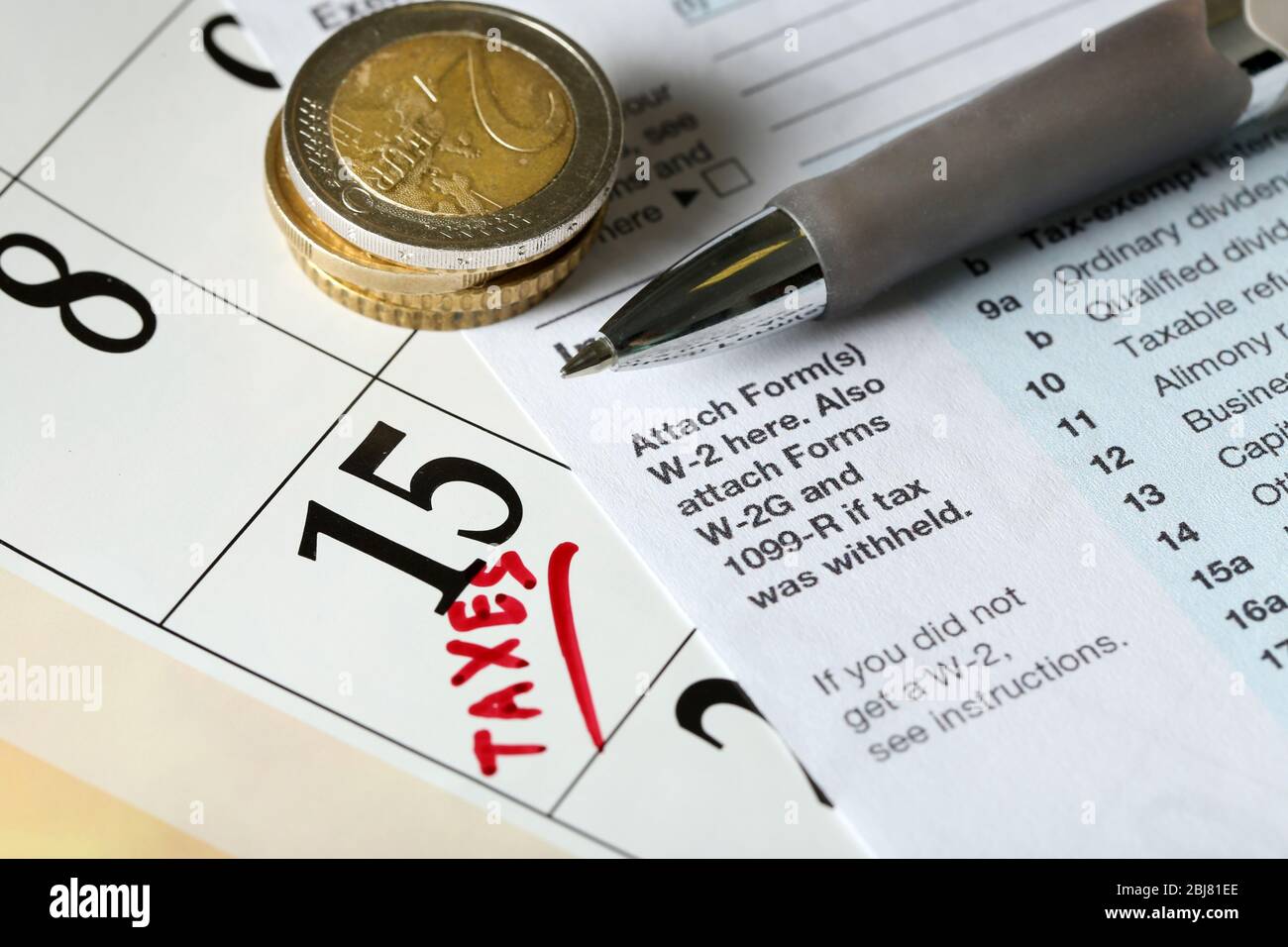A red tax mark in the calendar, euro coins and tax form, close up Stock ...