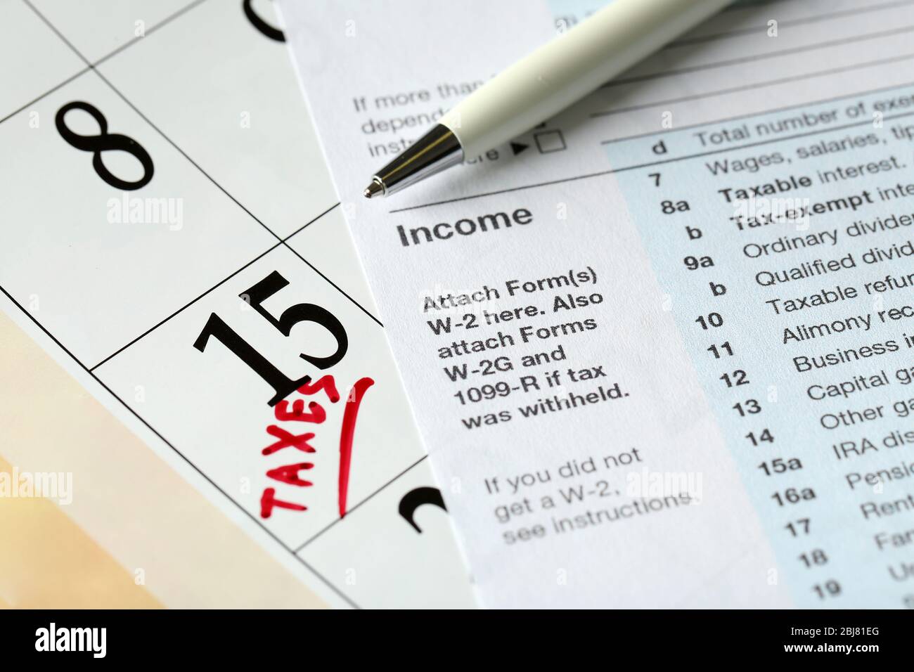 A red tax mark in the calendar, euro coins and tax form, close up Stock ...