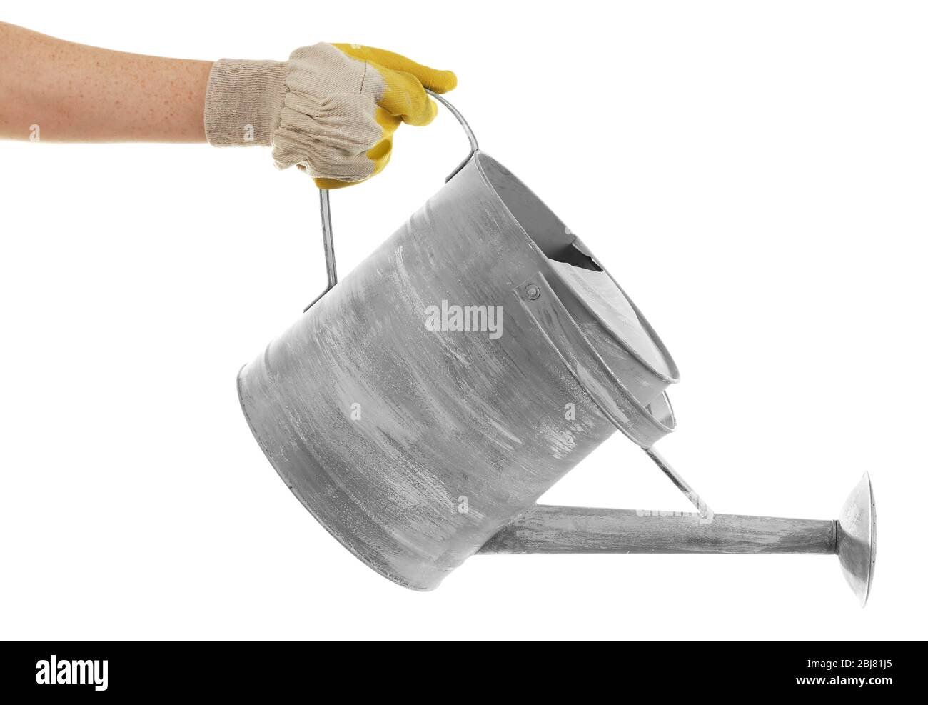 Female hand in a glove holding a simple aluminum watering can isolated ...