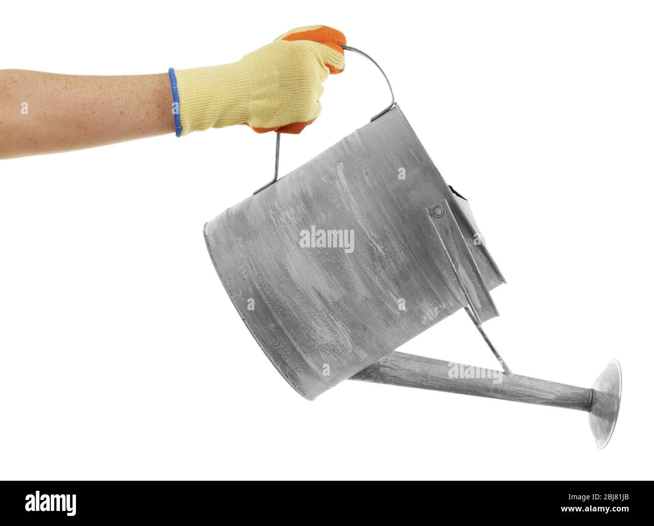 Female hand in a glove holding a simple aluminum watering can isolated ...