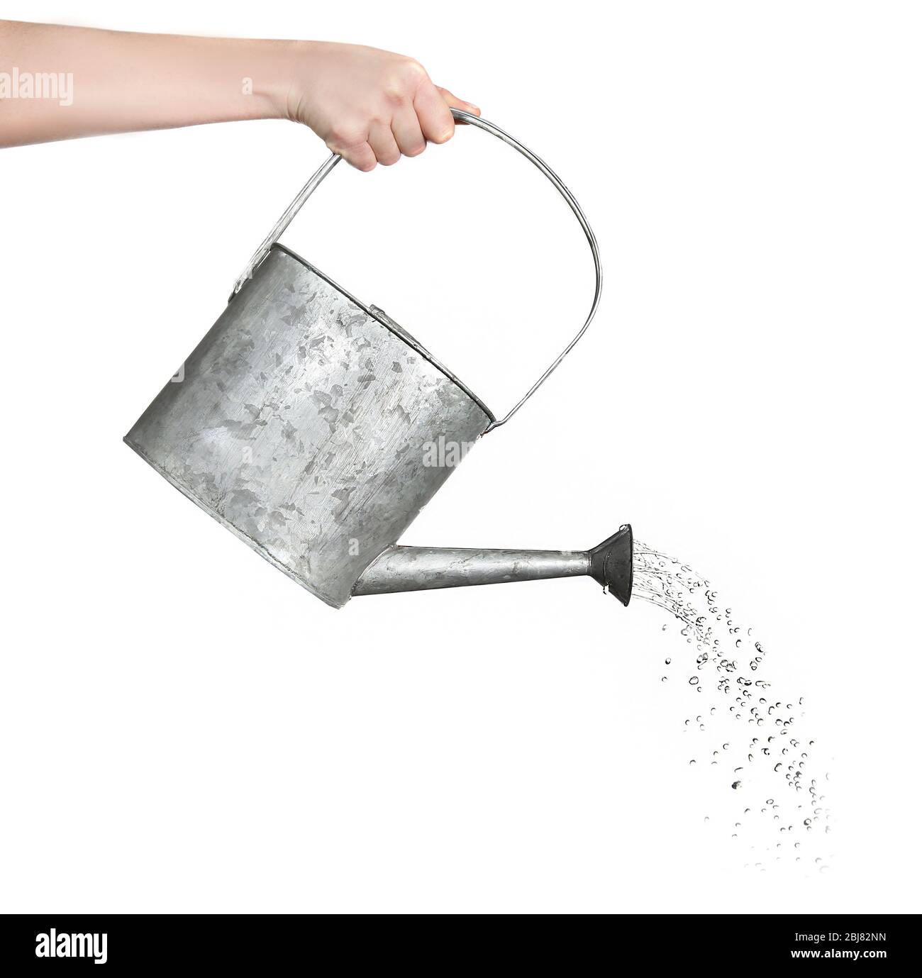 Female hand pouring water from metal watering can, isolated on white ...