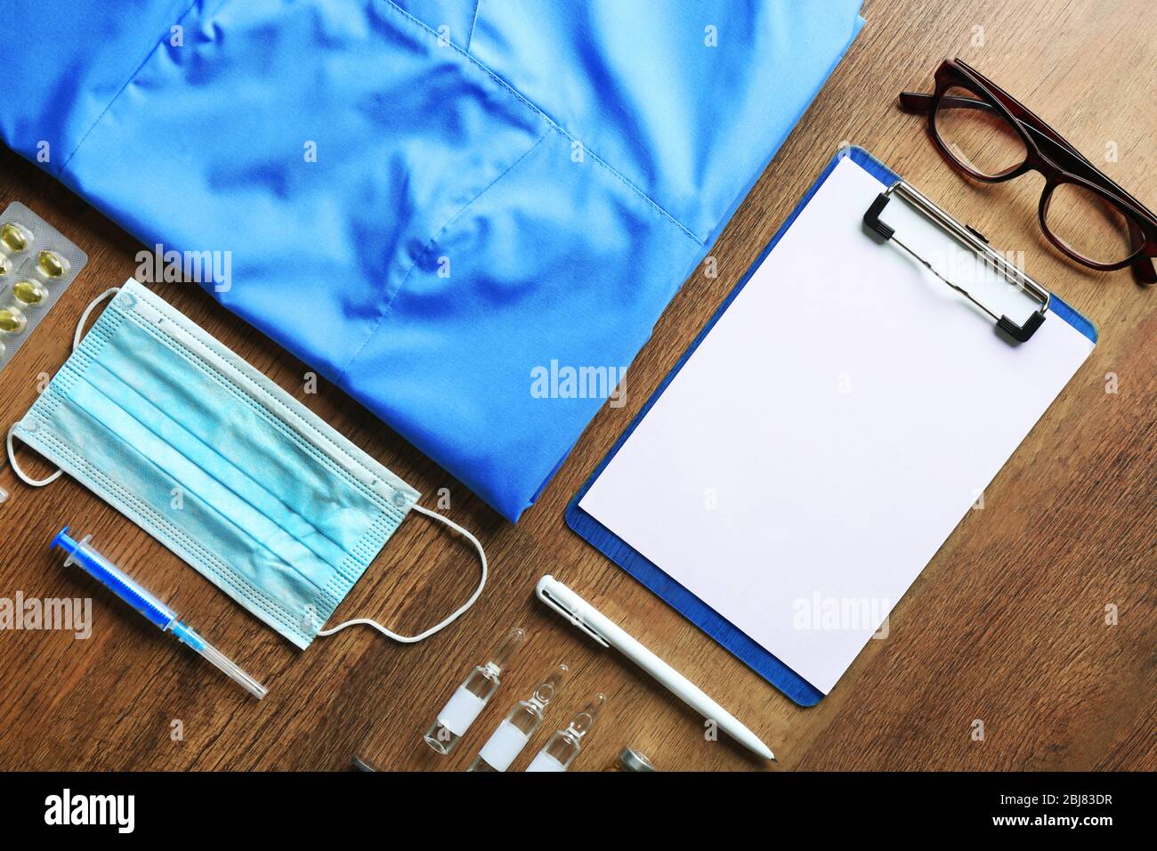 Doctor table with medicines and uniform, top view Stock Photo - Alamy