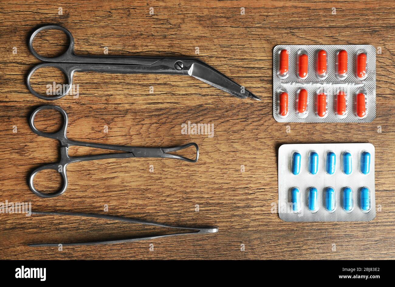 Doctor table with pills and surgical instruments, top view Stock Photo ...