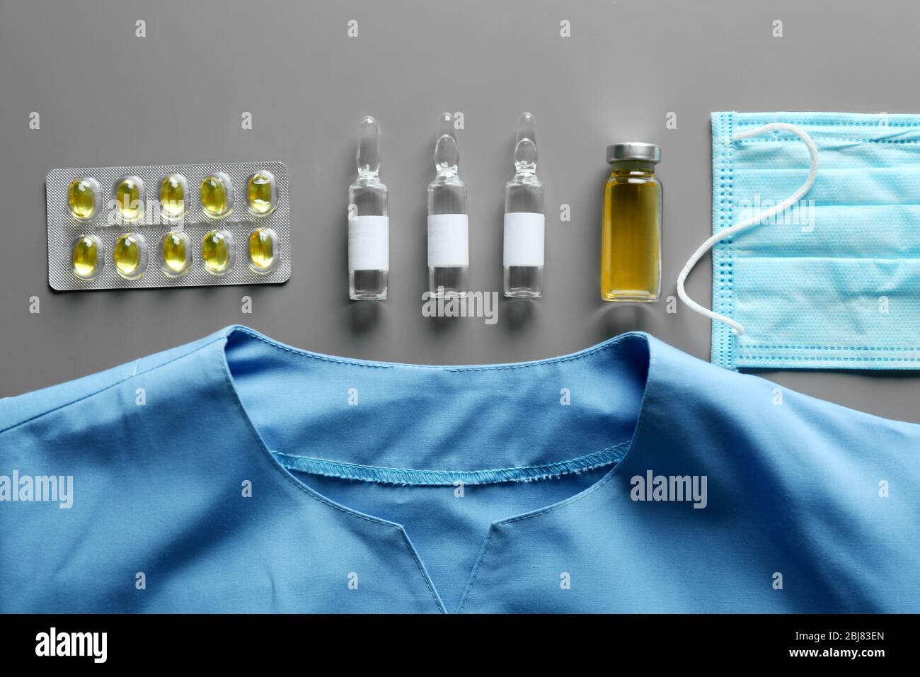 Doctor table with medicines and uniform, top view Stock Photo - Alamy